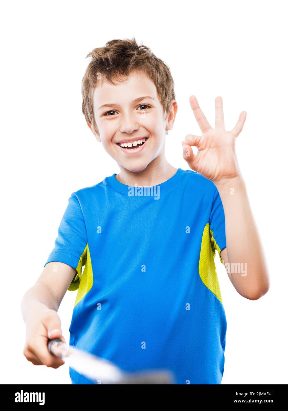 Handsome smiling child boy holding mobile phone or smartphone selfie stick taking portrait photo ...