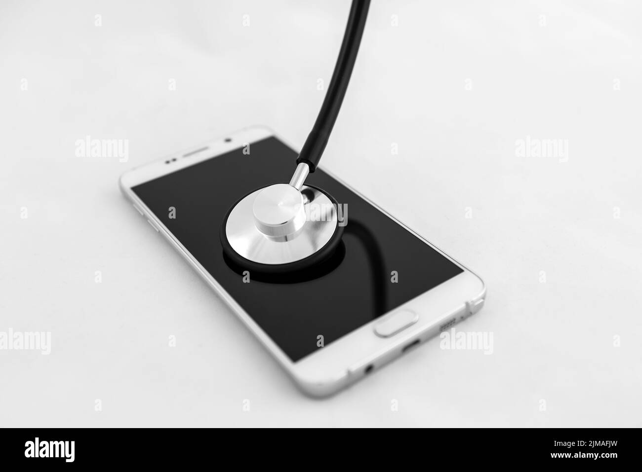 Medical stethoscope tool over the surface of a mobile smart phone Stock ...