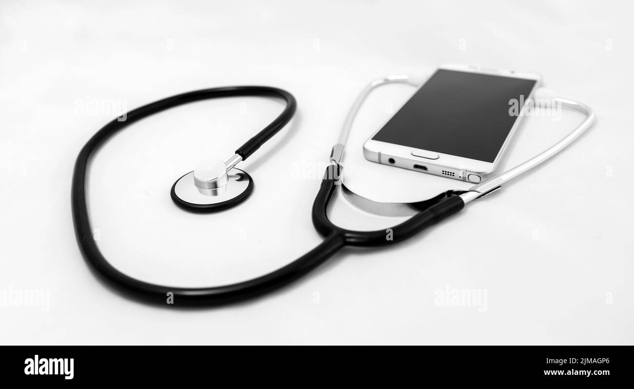 Medical stethoscope tool over the surface of a mobile smart phone Stock ...