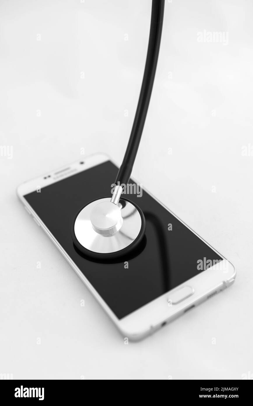 Medical stethoscope tool over the surface of a mobile smart phone Stock ...