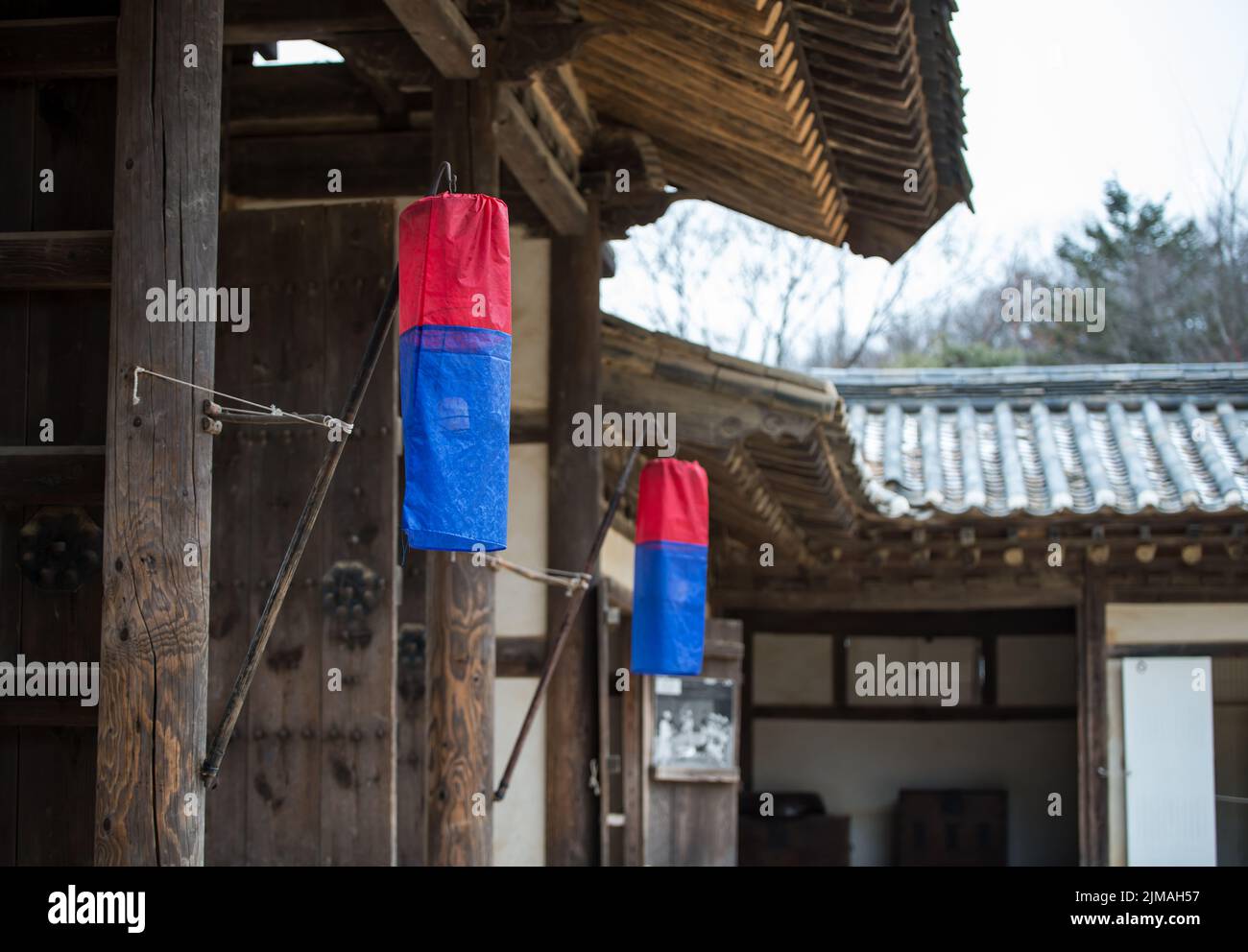 Traditional korean street lamp with blue and red flags in village with ...