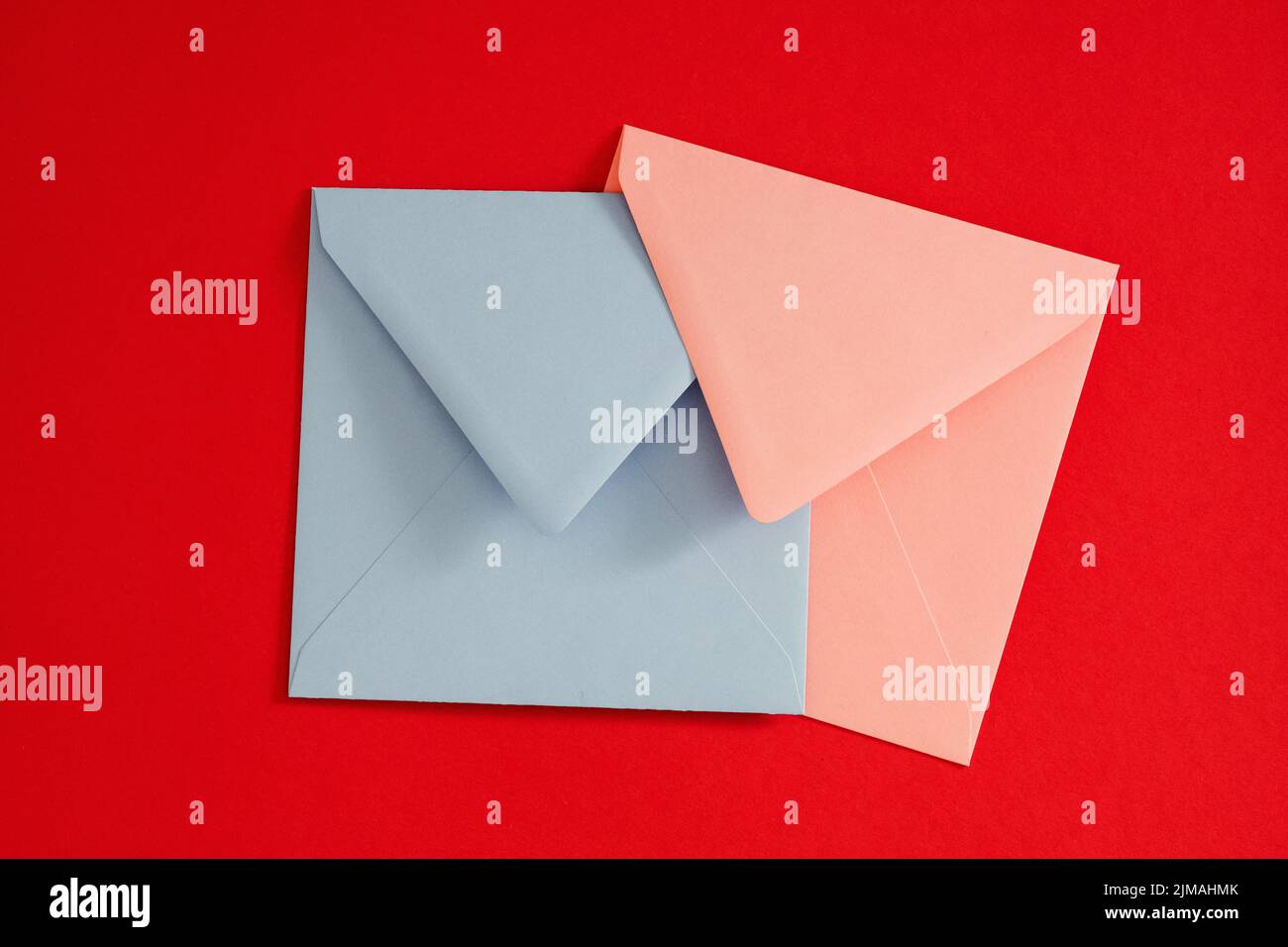 romantic mail blue pink envelopes red background Stock Photo - Alamy