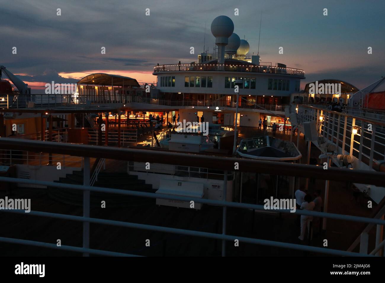 Blur On the open deck of a cruise ship on a calm day, with the coast in ...