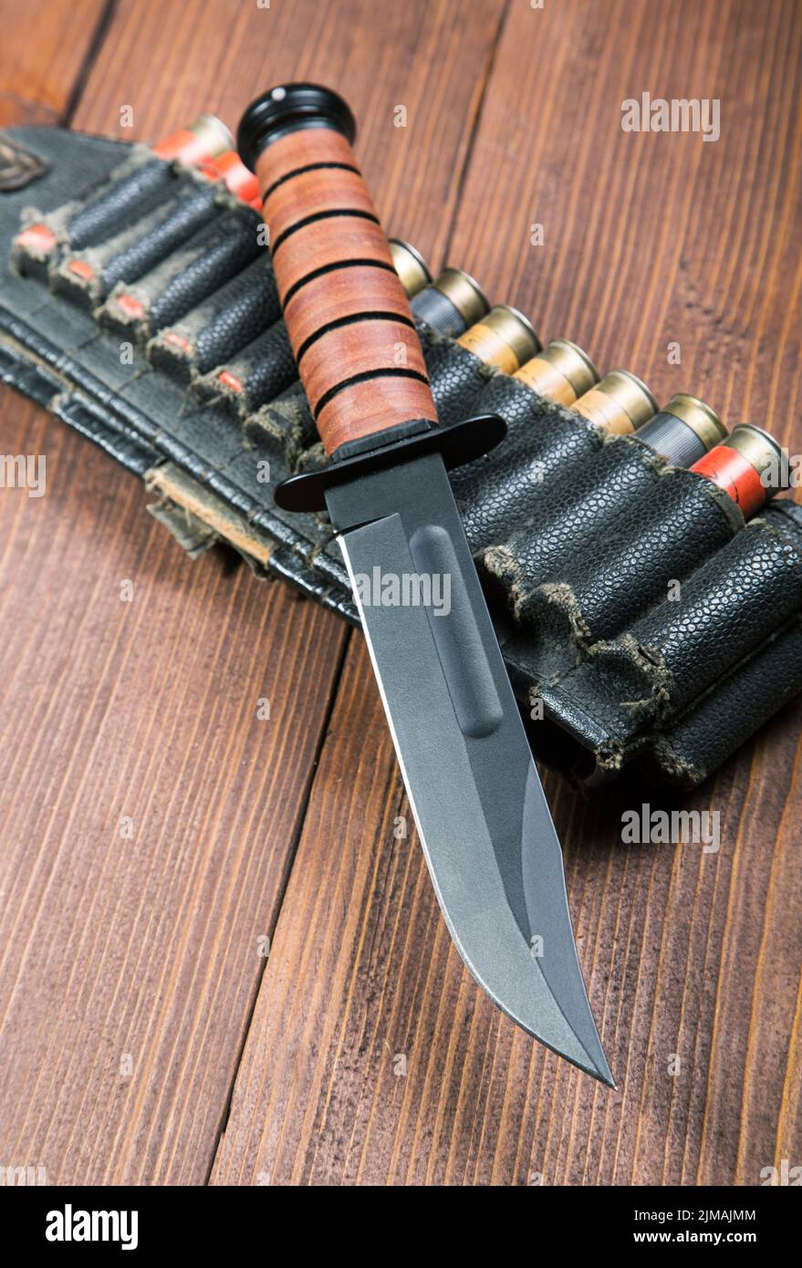 Still life with a knife and bandolier on a close-up table Stock Photo ...
