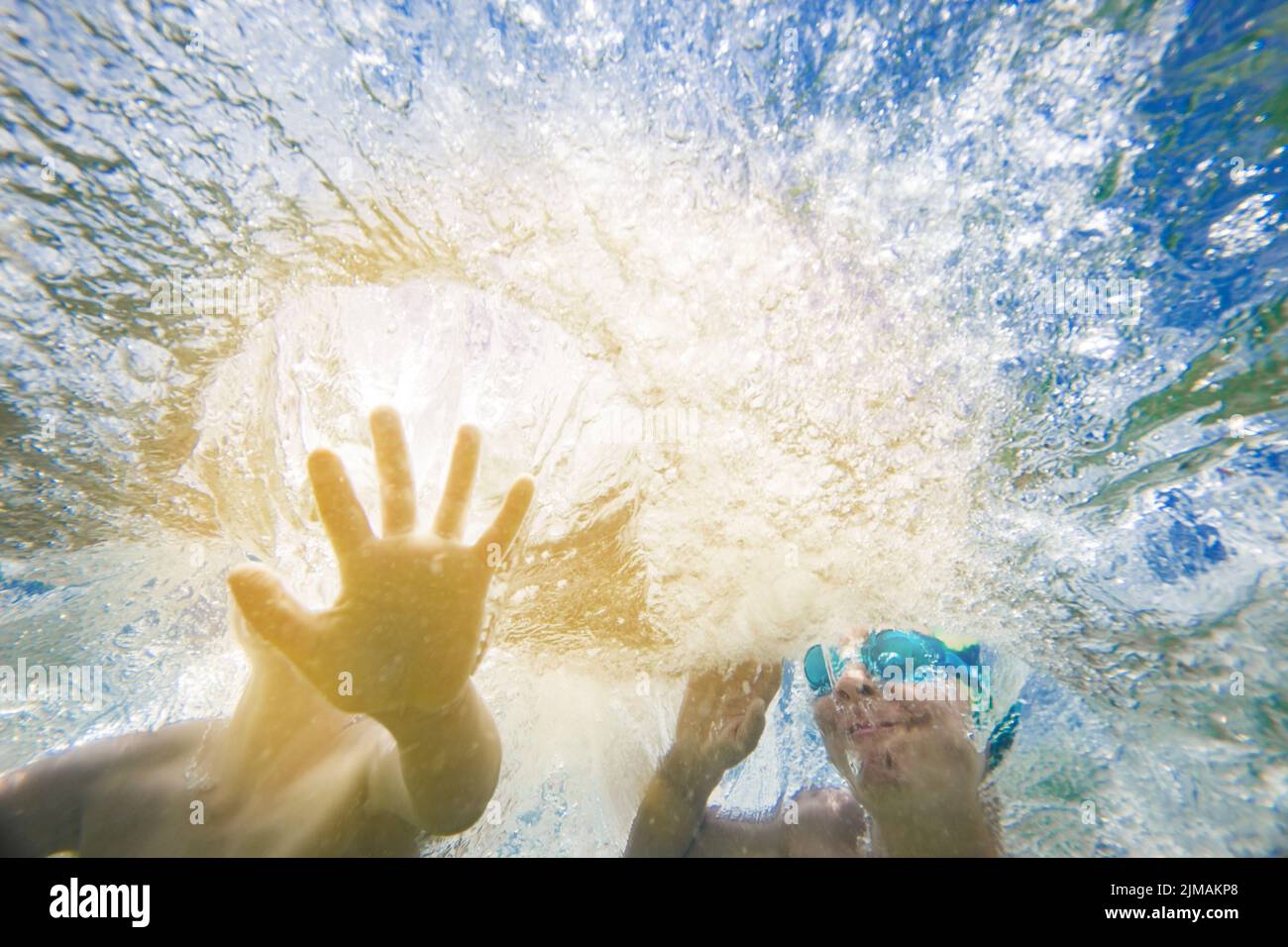 Kids Splashing Hands Underwater Stock Photo - Alamy