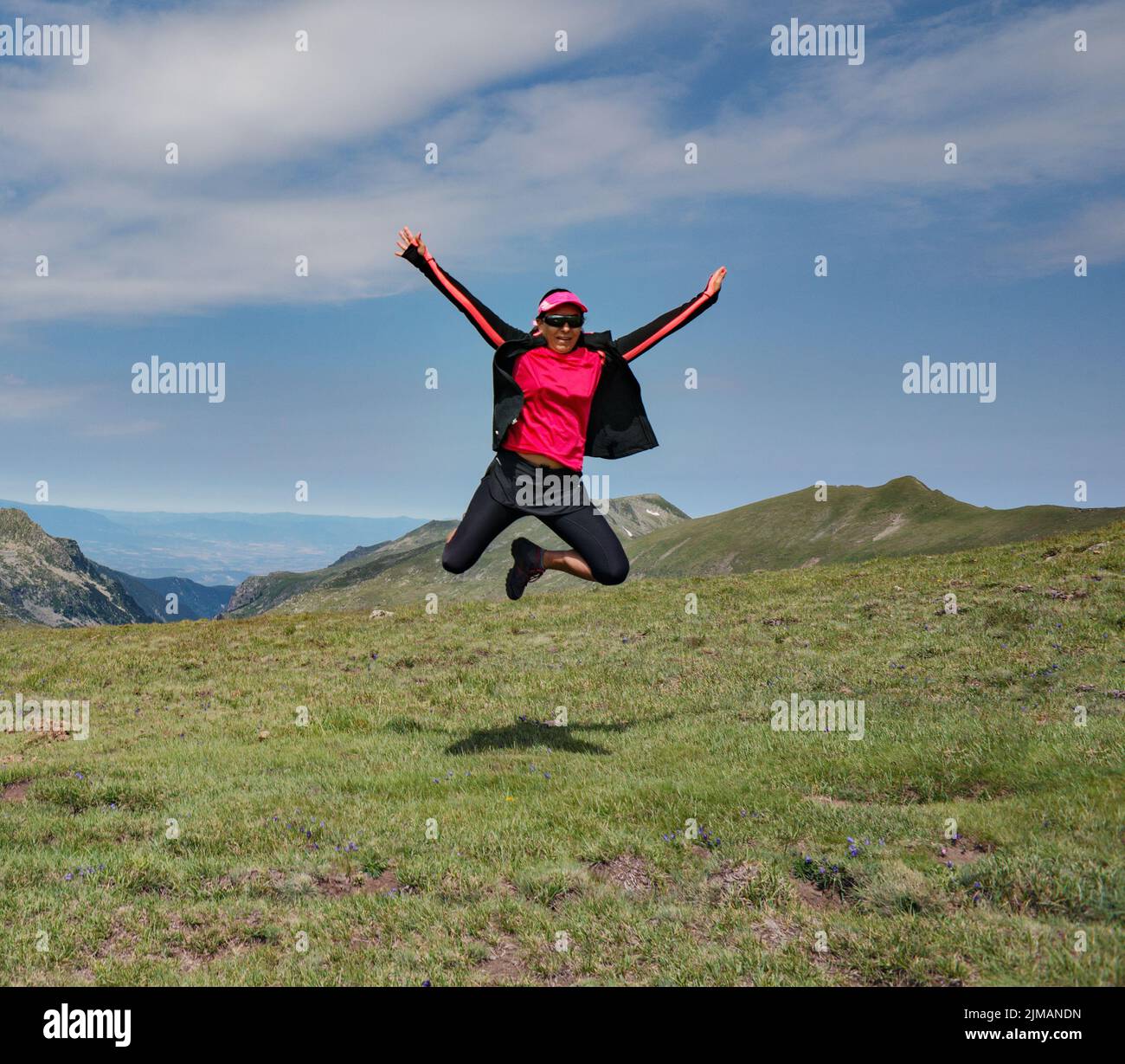 Jumping Female Mountain Stock Photo - Alamy