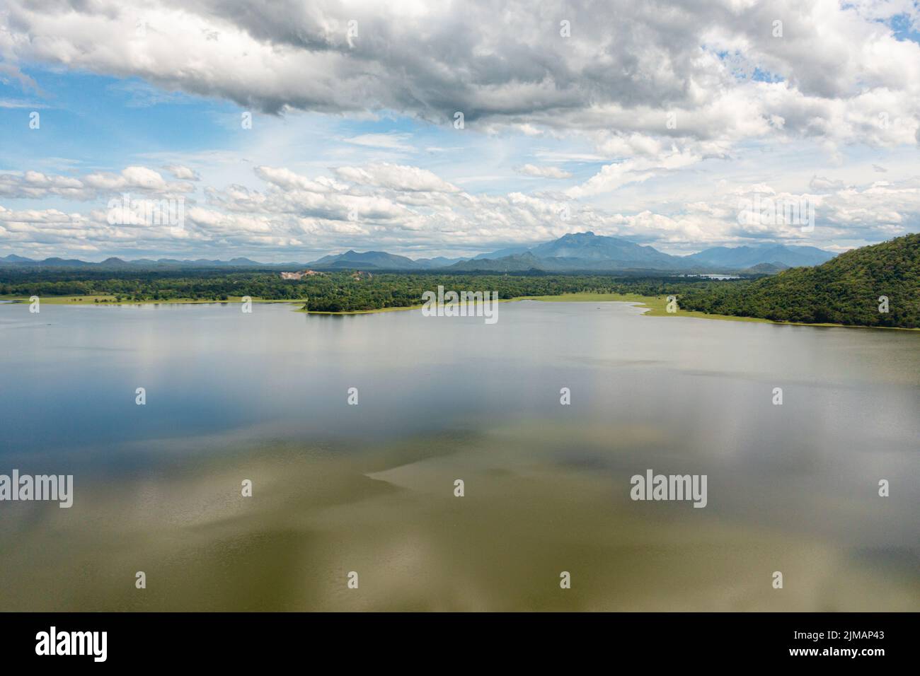 Aerial view of valley with a lake and tropical vegetation against a ...