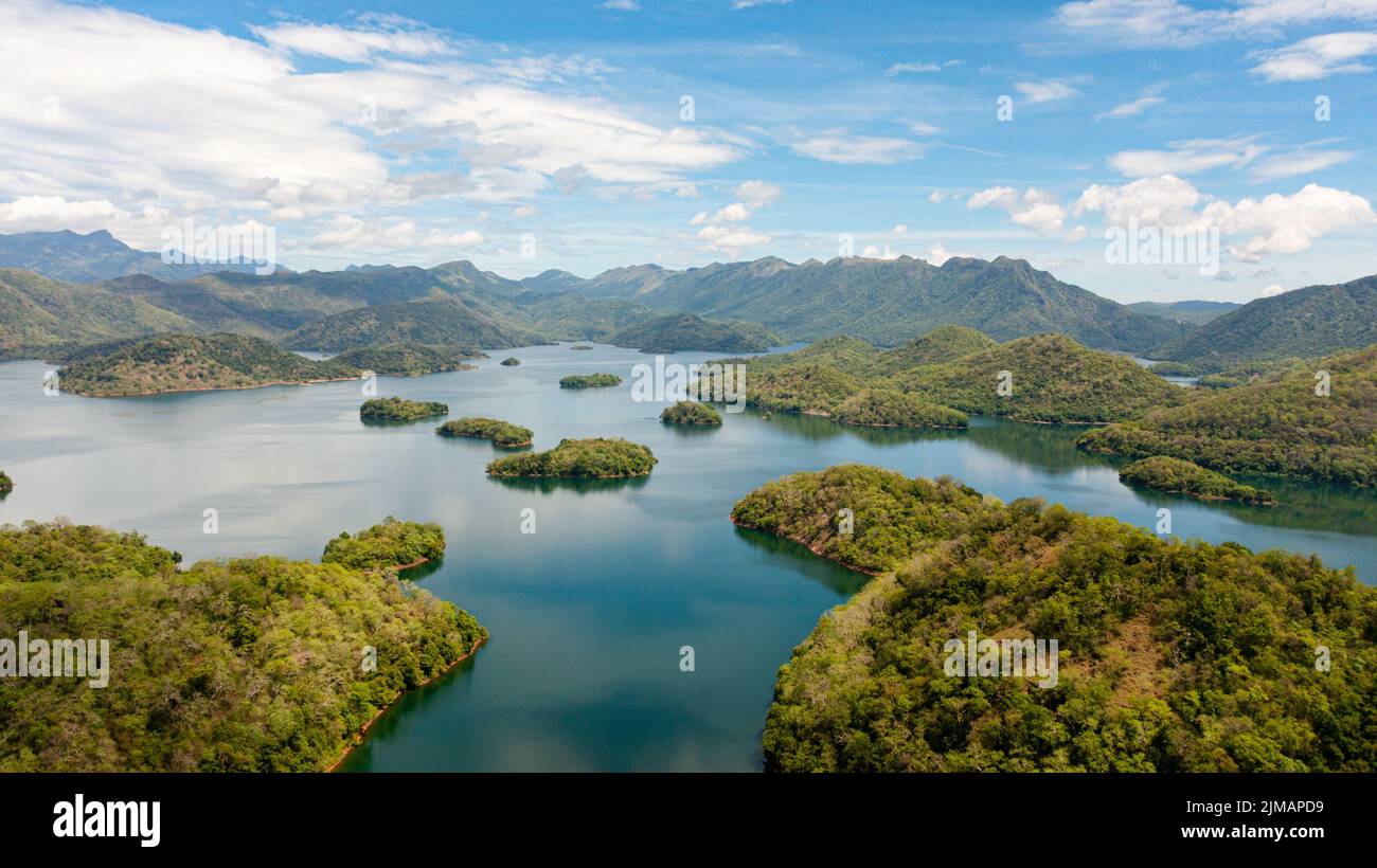 Aerial drone of lake and islands among mountains and hills against the ...