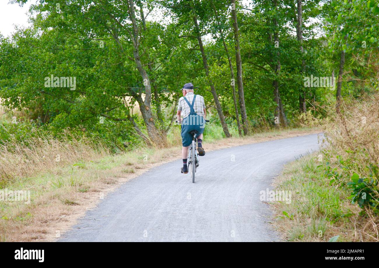 Old man on bike by river hi-res stock photography and images - Alamy