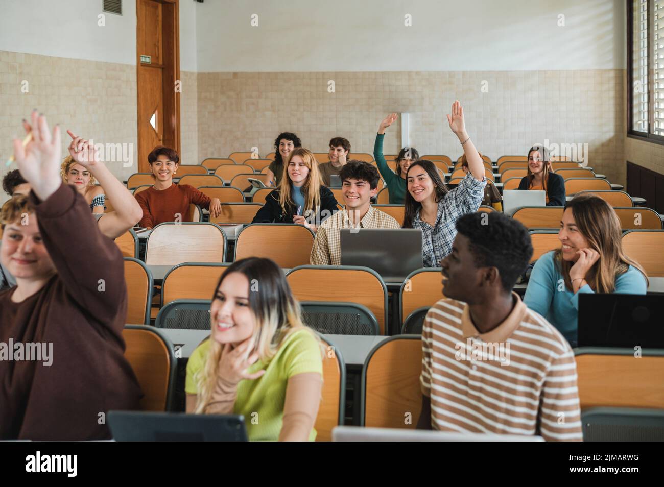 Students wishing to answer question Stock Photo - Alamy