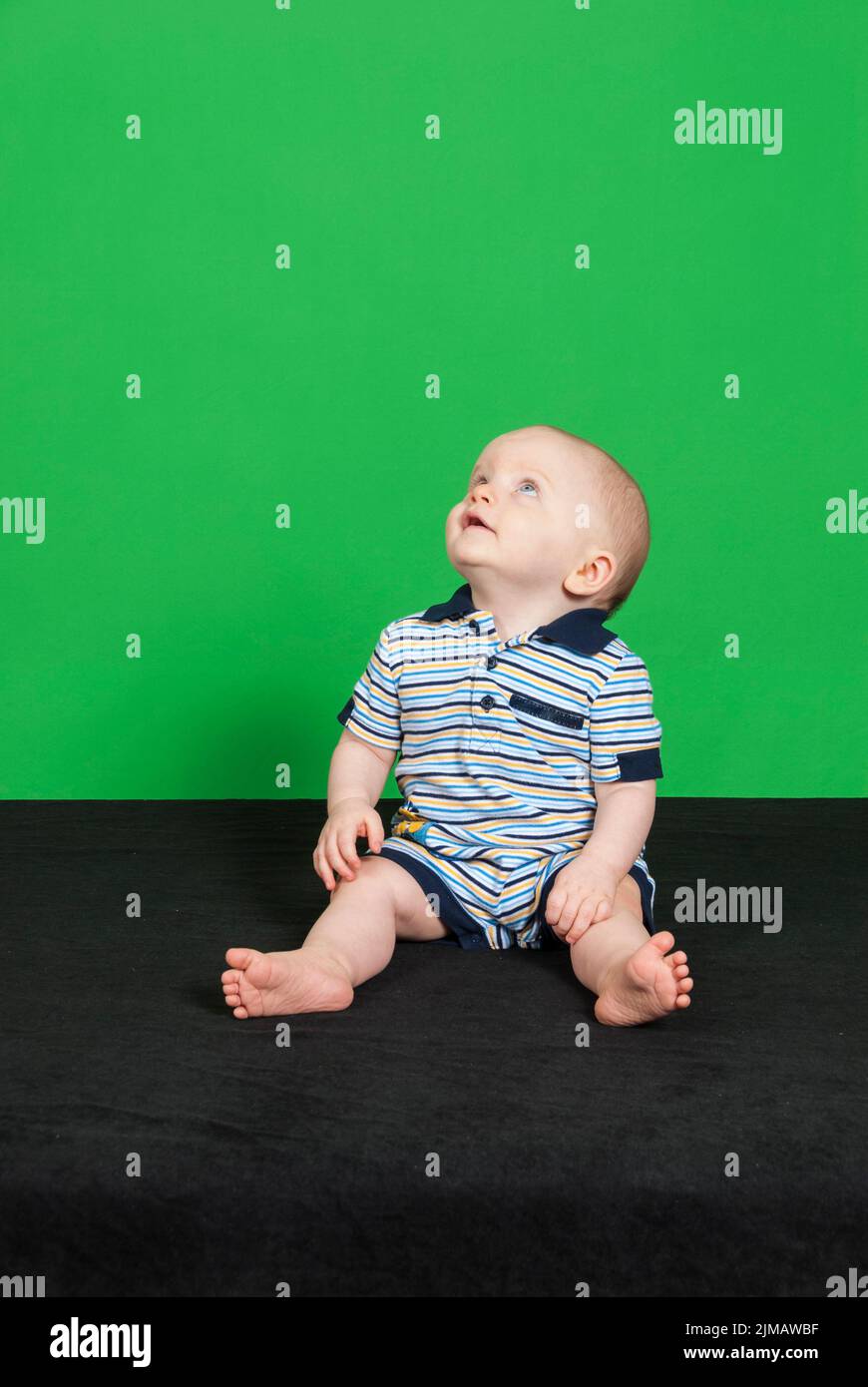 10 Month Old Baby Boy on a Green Background pt 4 Stock Photo - Alamy
