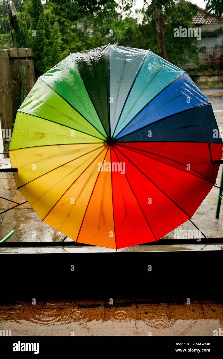 Rainbow umbrella in the rainy season Stock Photo - Alamy