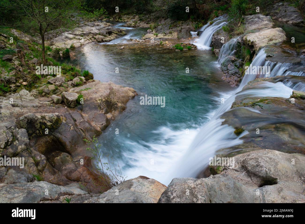 Waterfall with great flow of water in the pools of Loureza. Oía - Spain ...