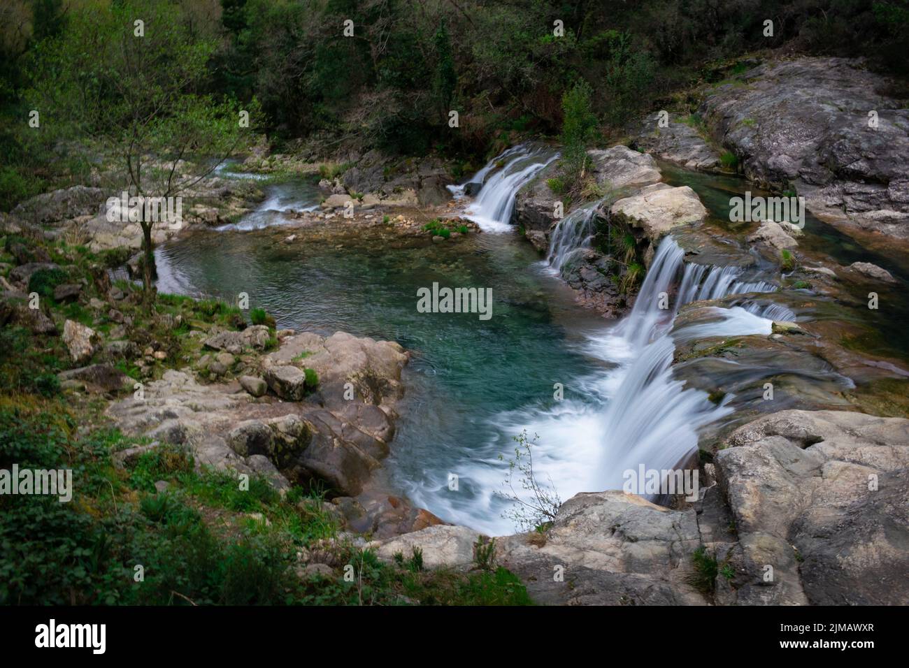 Waterfall with great flow of water in the pools of Loureza. Oía - Spain ...