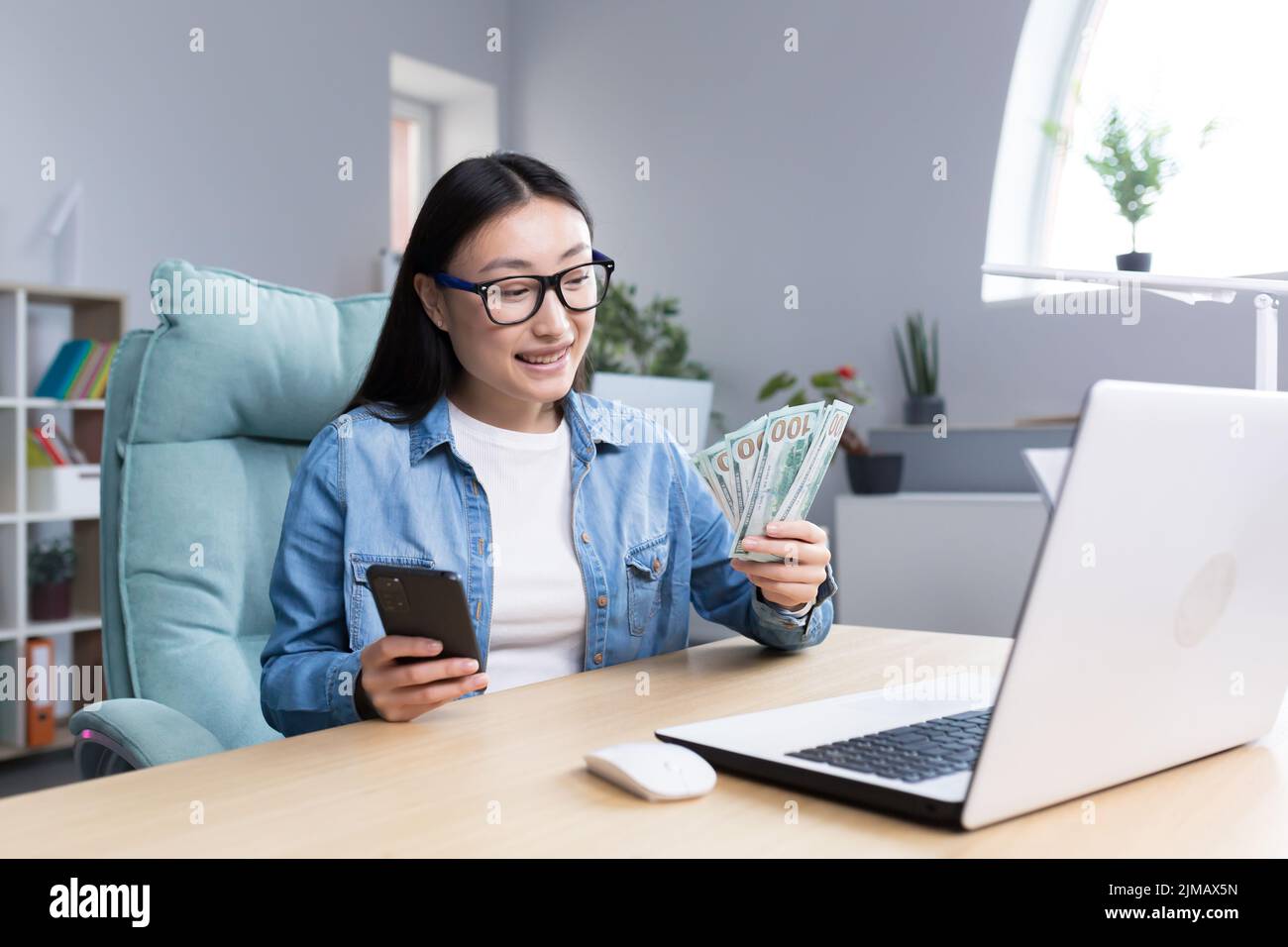 Business training about money. A young Asian business woman conducts a ...