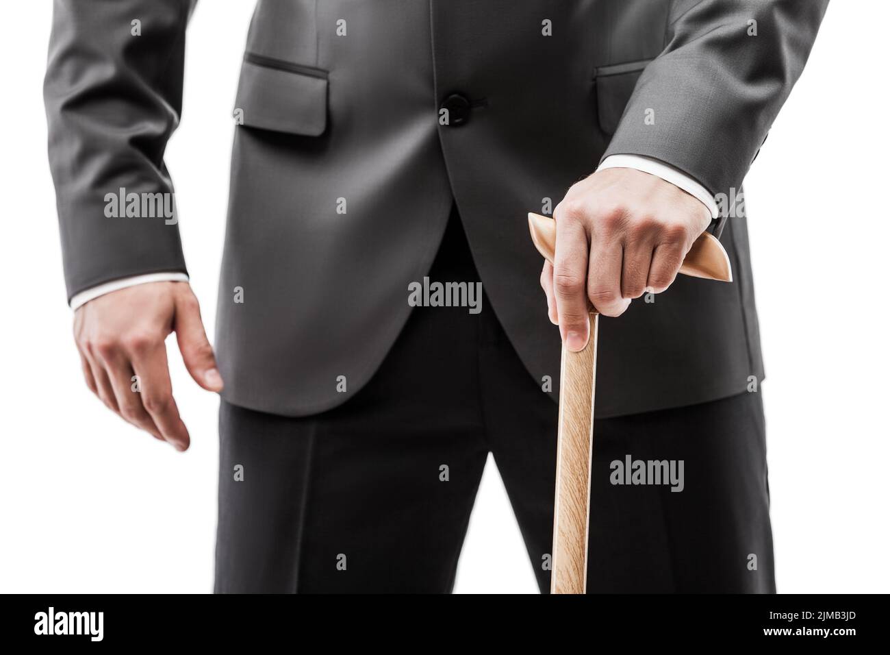 Businessman in black suit holding walking cane stick Stock Photo - Alamy