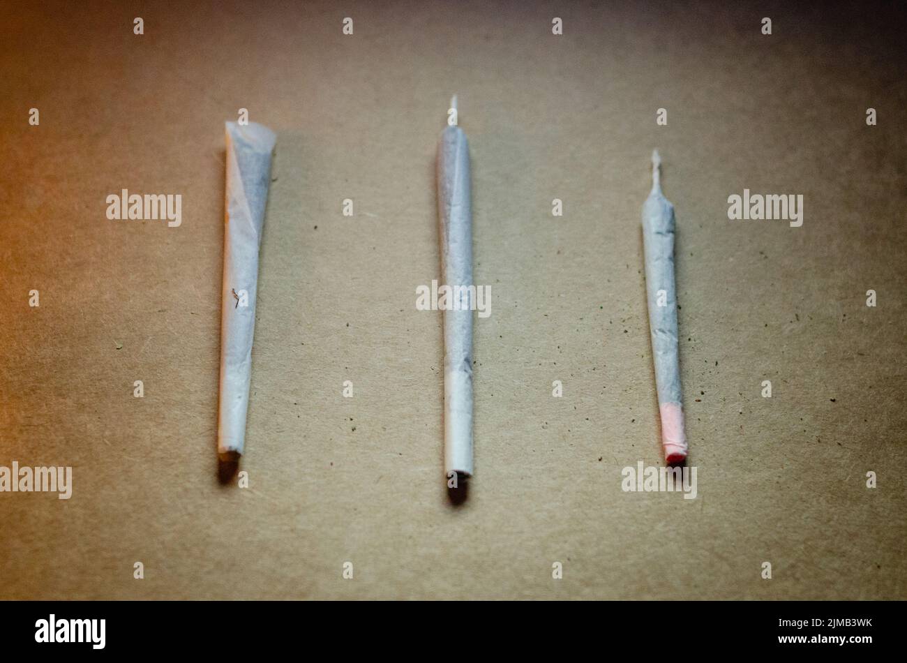 a Top view three handmade marijuana joint, cannabis cigarettes placed ...