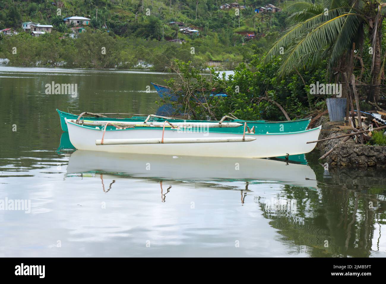The small fishing boats with rural houses in the background in the ...