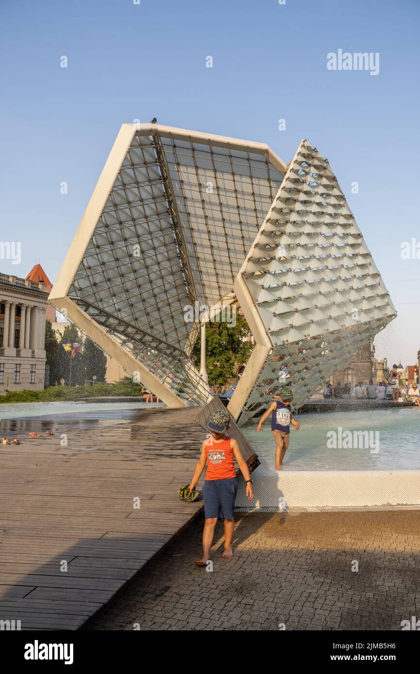 The Children playing with water close by a large fountain in the Plac ...
