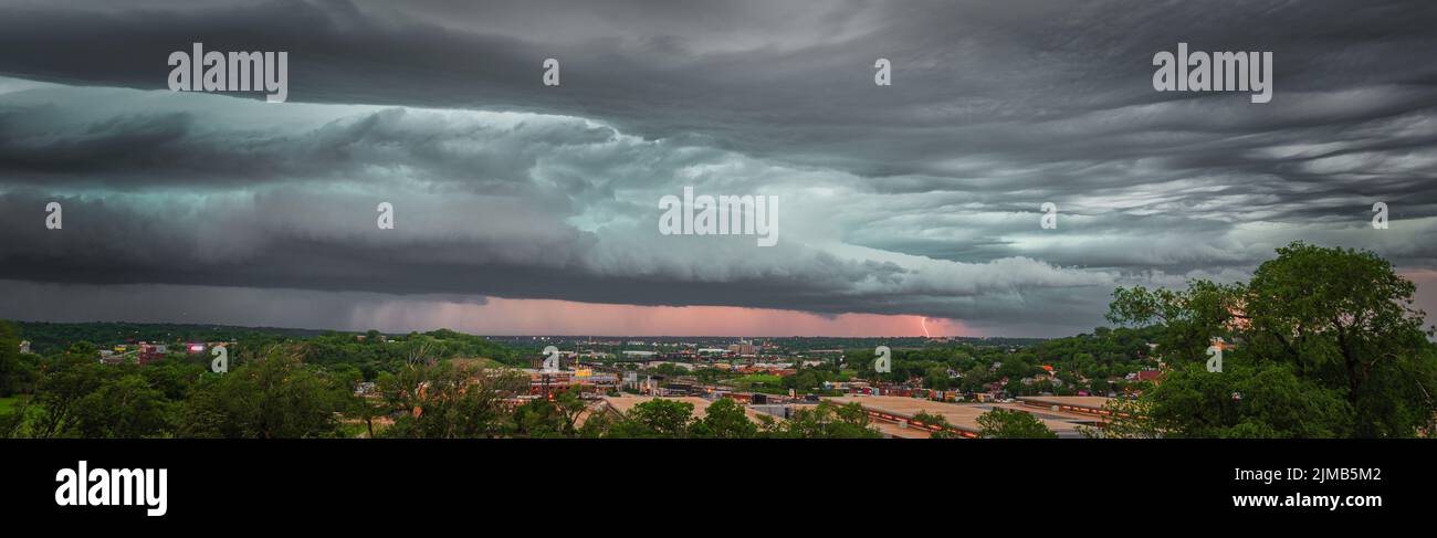 A panoramic view of a brewing storm with lightning striking over a city ...