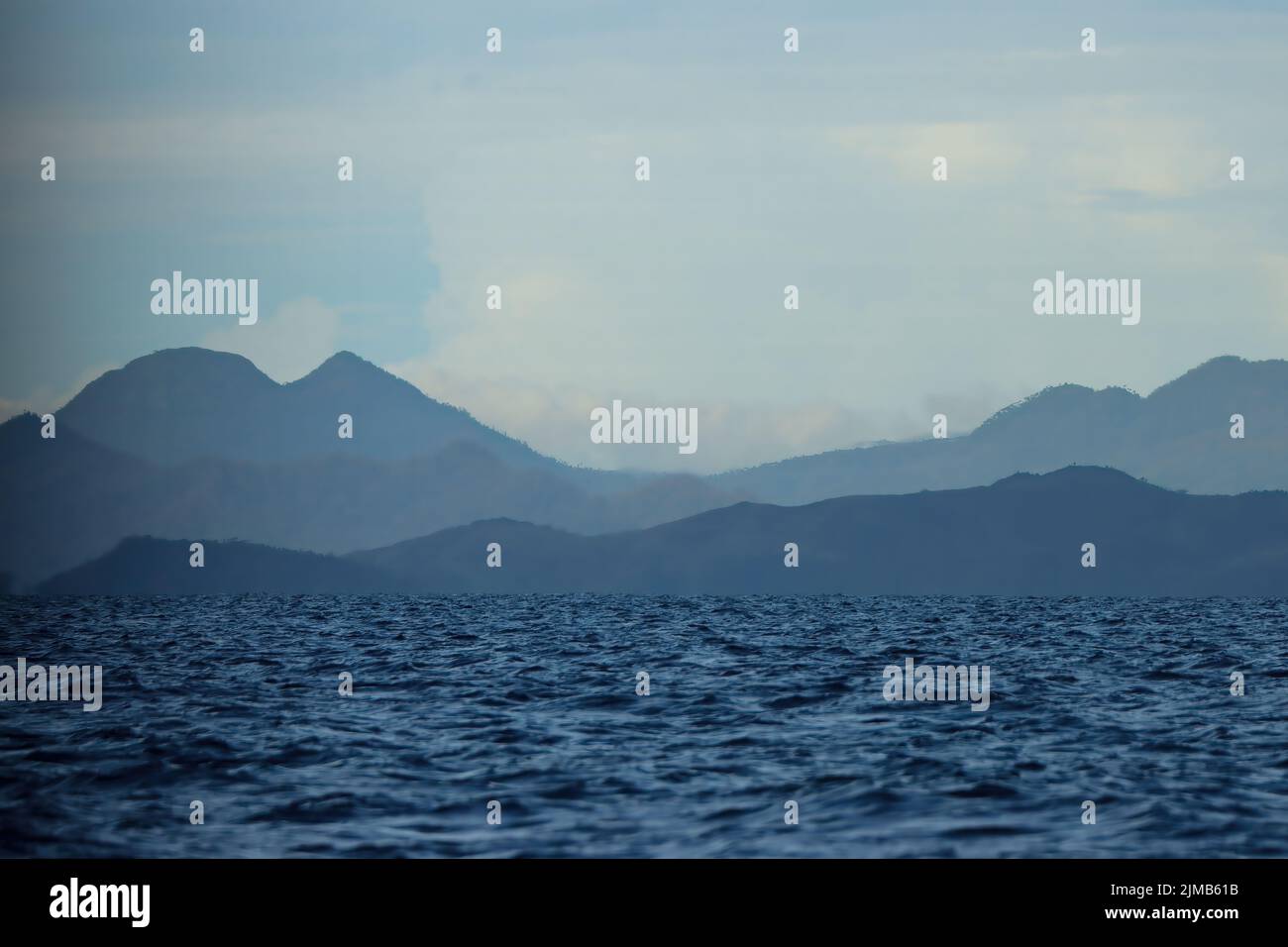 A peaceful seascape with mountains and a skyline in the Philippines ...