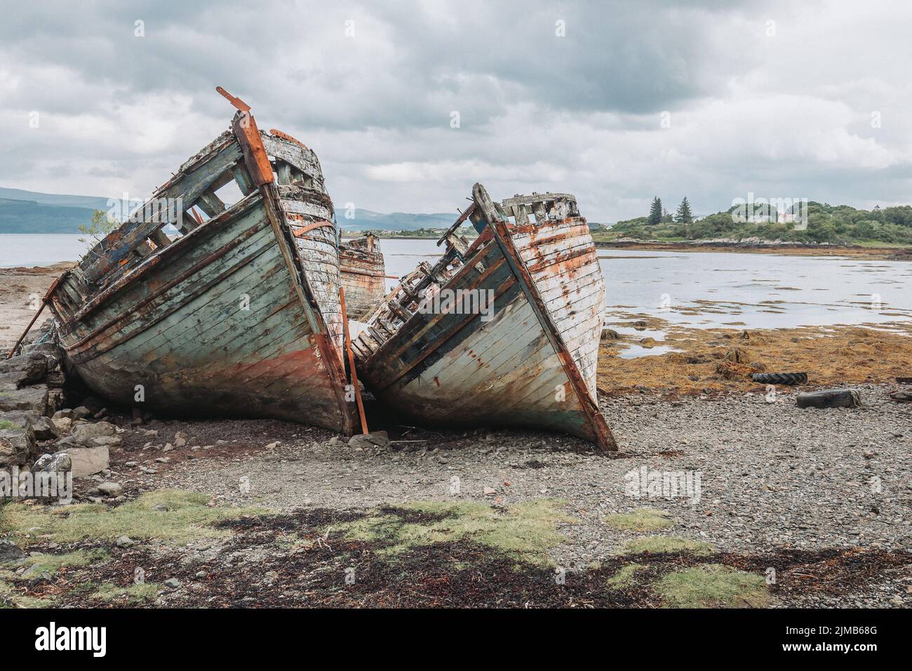 A view of two wrecked ships on a sandy beach of a sea in Scotland Stock ...