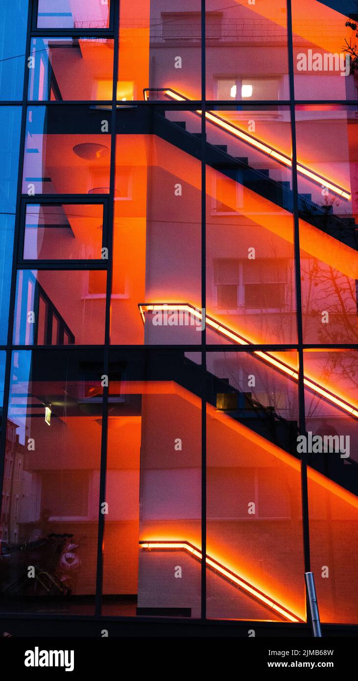 A vertical shot of a modern building with transparent walls and ...