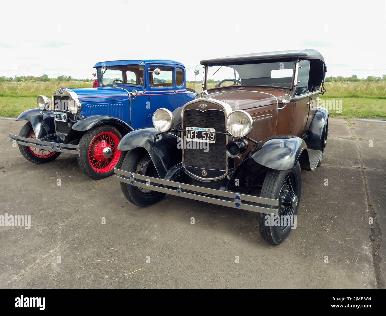 Old brown Ford Model A Phaeton Fordor four door and blue coupe Tudor ...