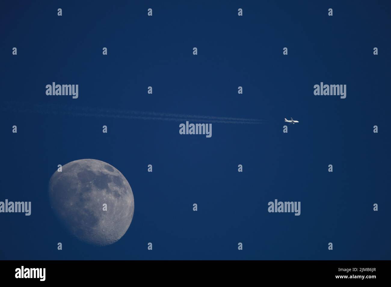 A beautiful shot of a plane flying in a cloudless blue sky near the ...