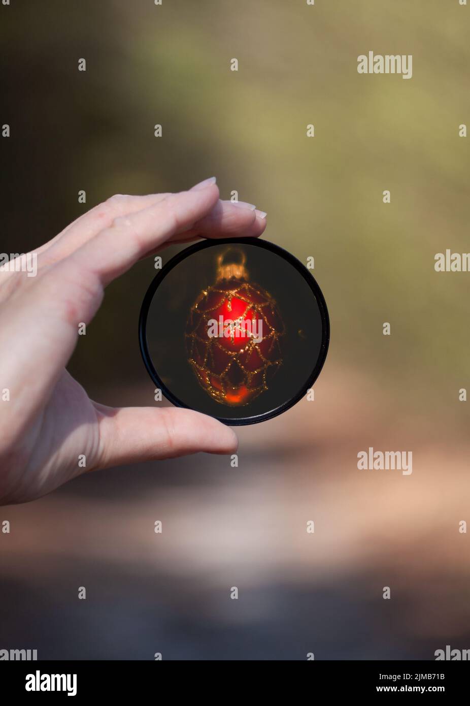 A vertical shot of a hand holding magnifying glass analyzing a Stock ...
