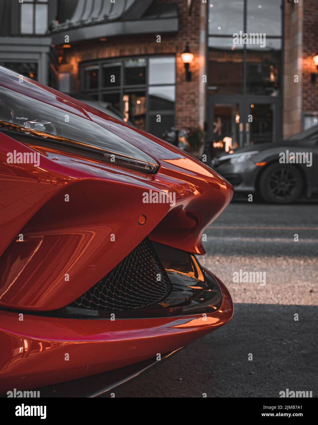 A vertical closeup shot of a back part of a modern car standing on a ...
