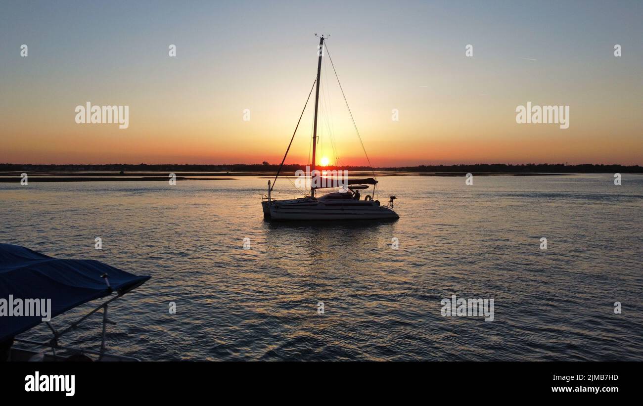 A sailboat at sun going through its empty sails Stock Photo - Alamy
