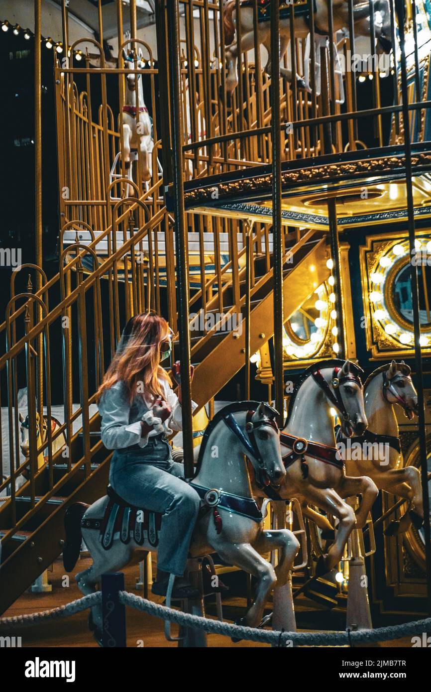 Woman riding carousel horse hi-res stock photography and images - Alamy