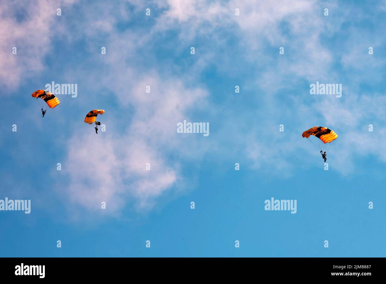 3 men, Army parachutists, descending in sky, colorful parachutes ...