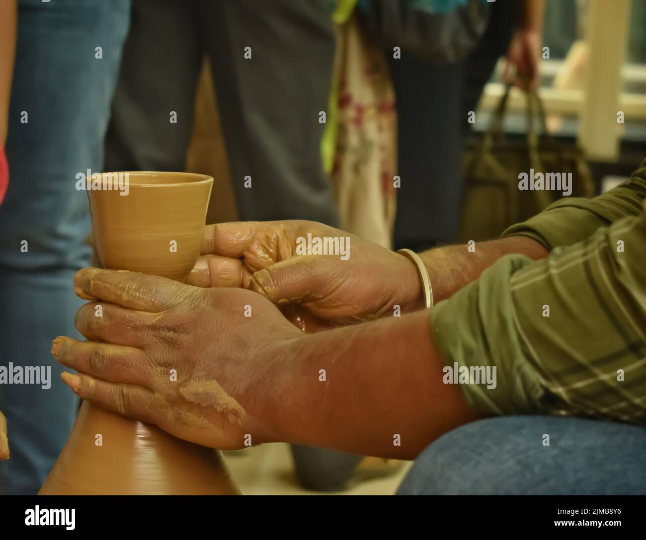 A closeup view of a man making Clay Pot in a mall in India with ...