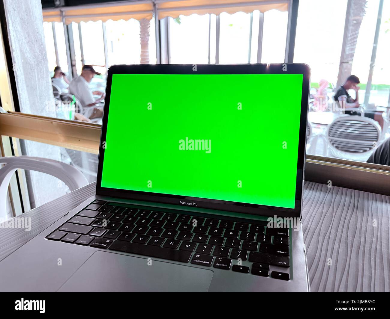 A Mockup image of laptop with blank green screen on on the table Stock ...