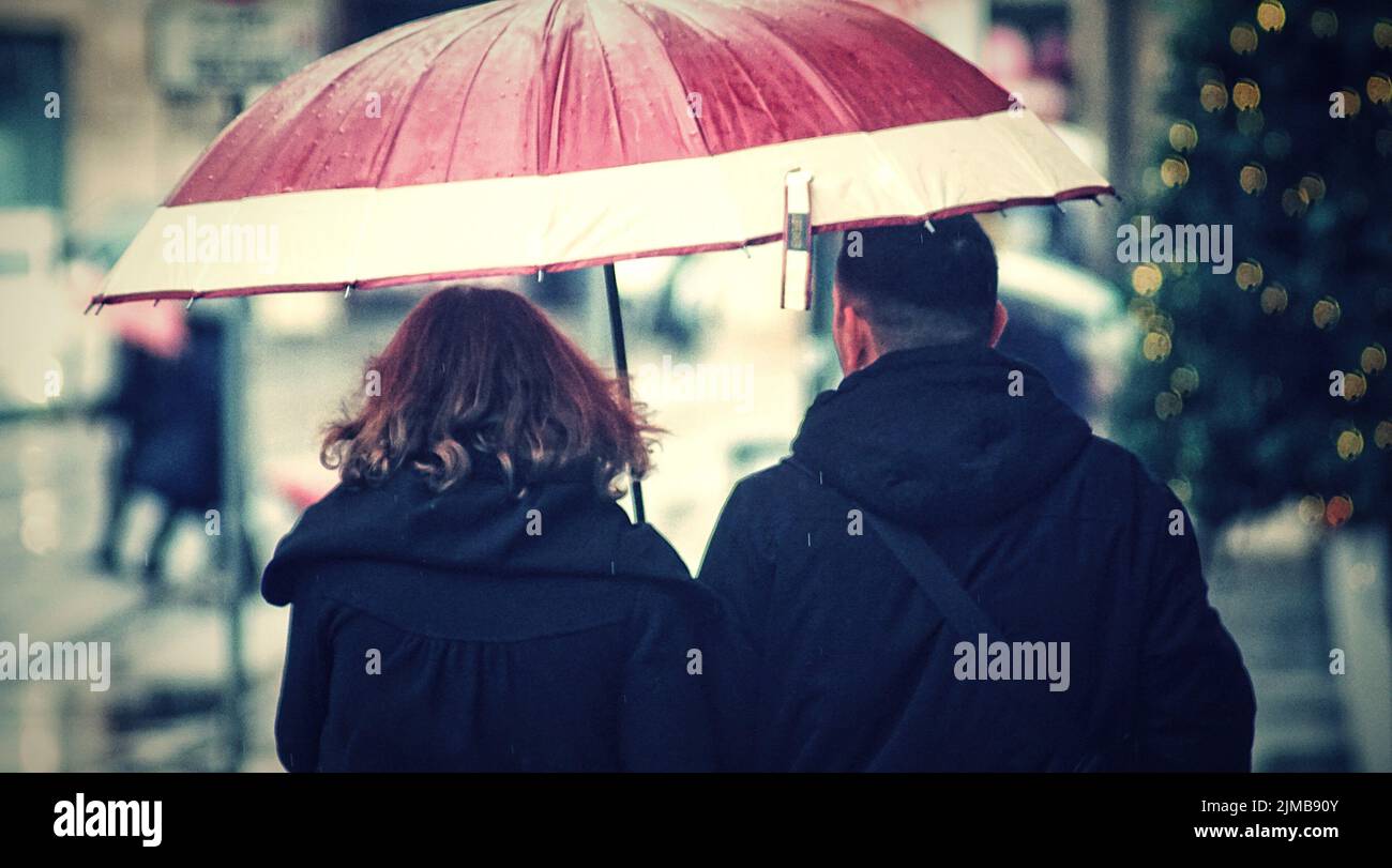 A back view of a couple walking on a rainy day Stock Photo - Alamy