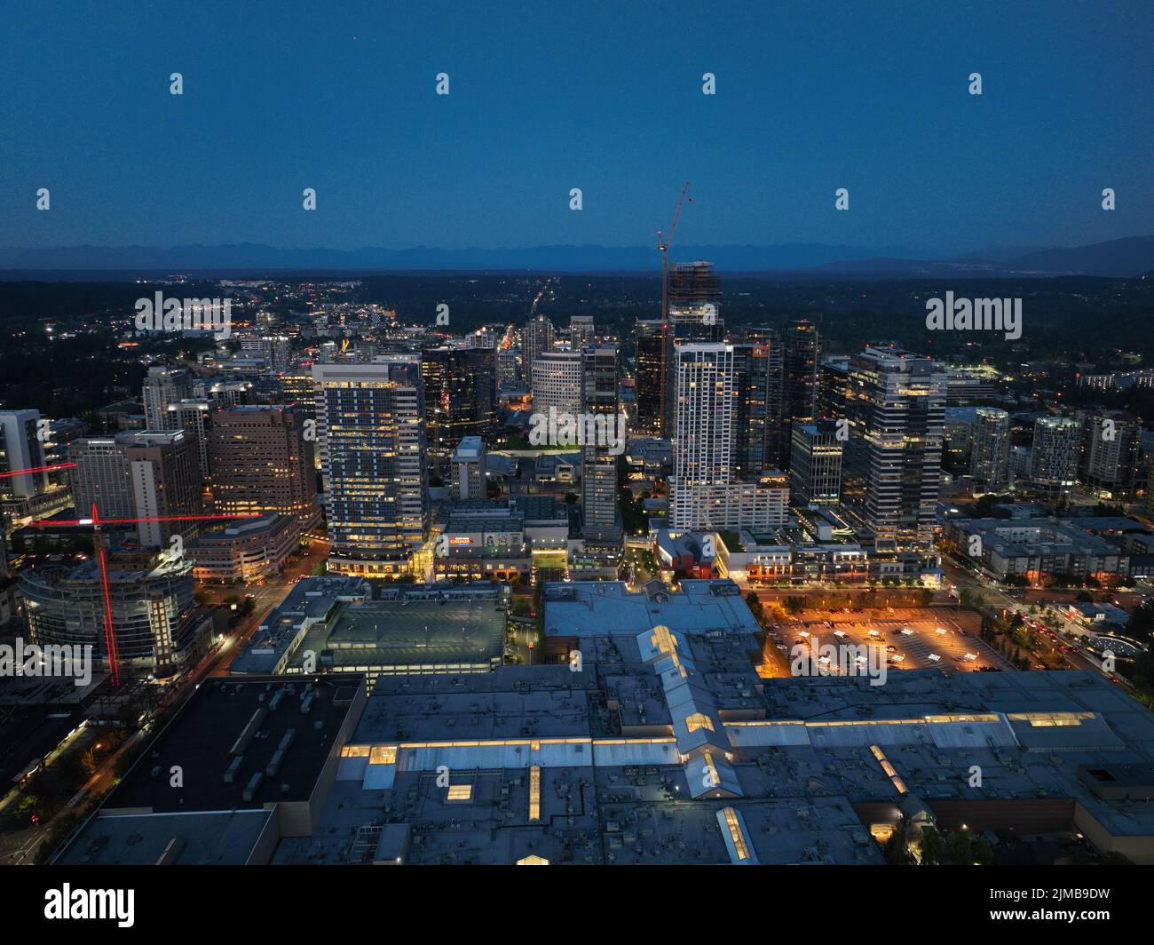 An aerial shot of the lit-up city of Bellevue at night in Washington ...