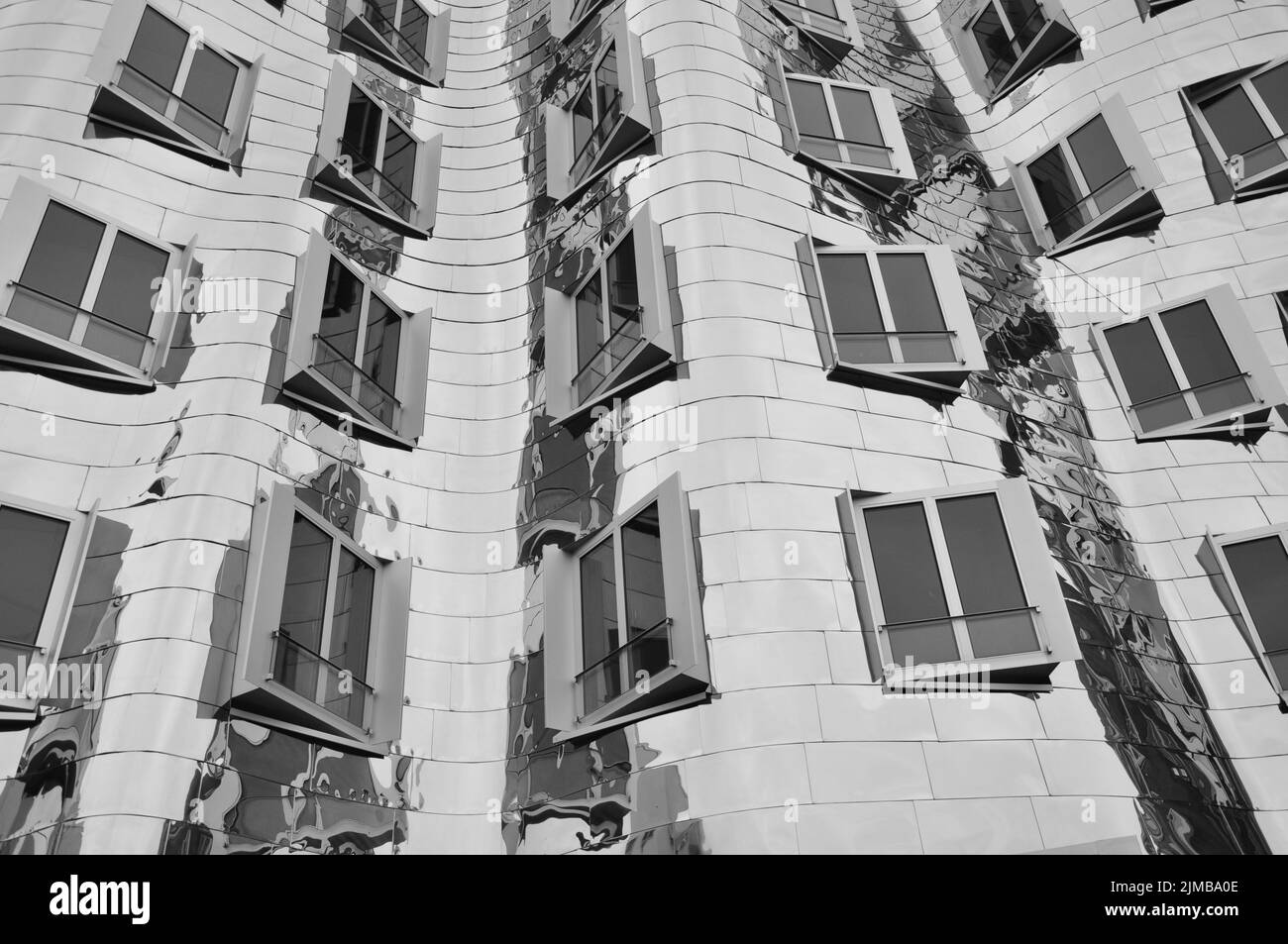 The mirrored metal facade of the Gehry buildings at the Media Harbour ...