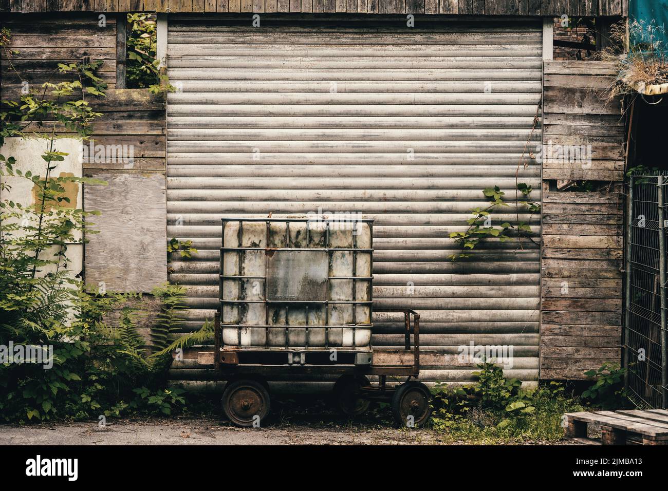 An industrial old cart next to an abandoned wooden village building ...