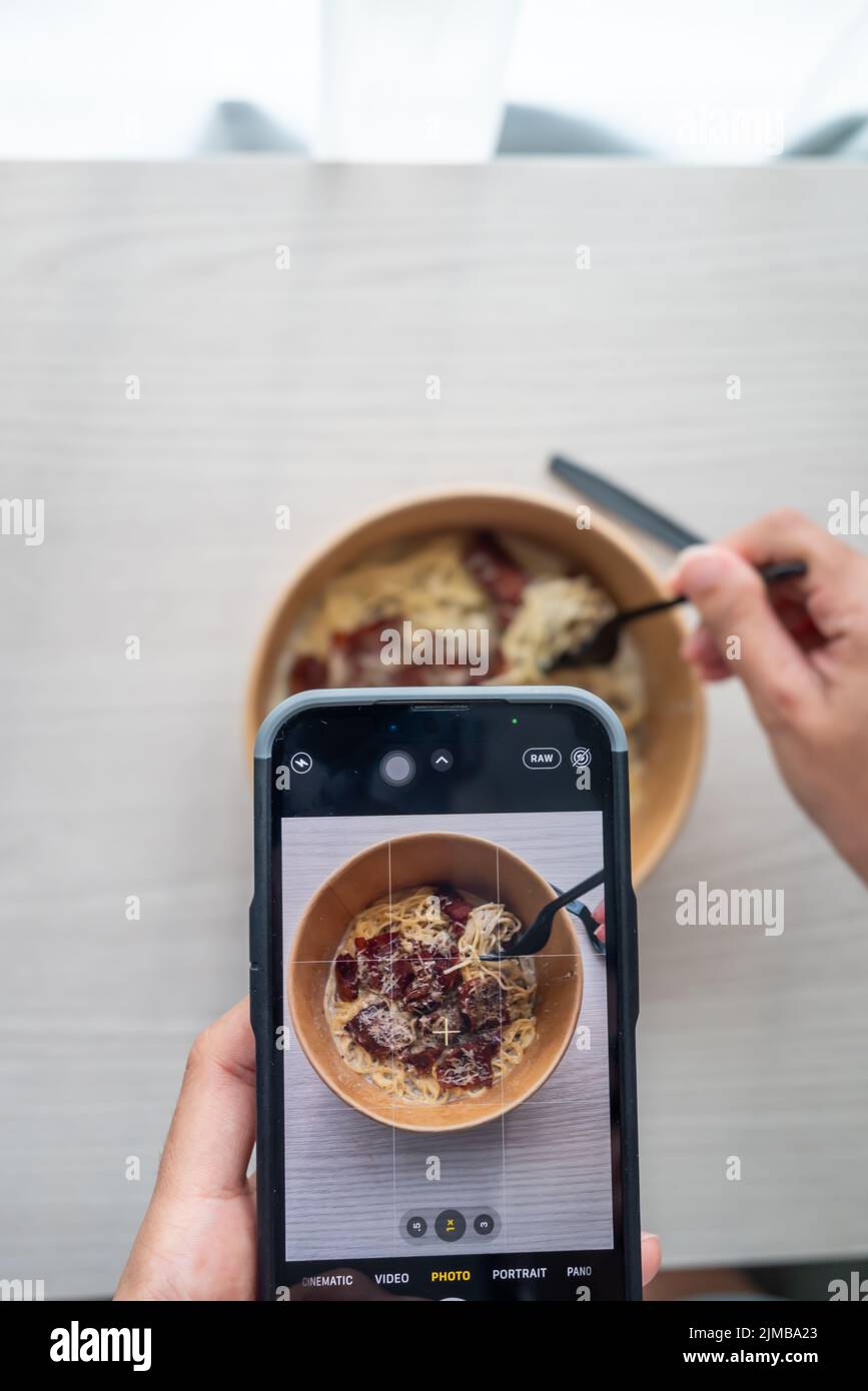 Shoot first eat later concept, shooting truffle white sauce pasta top ...