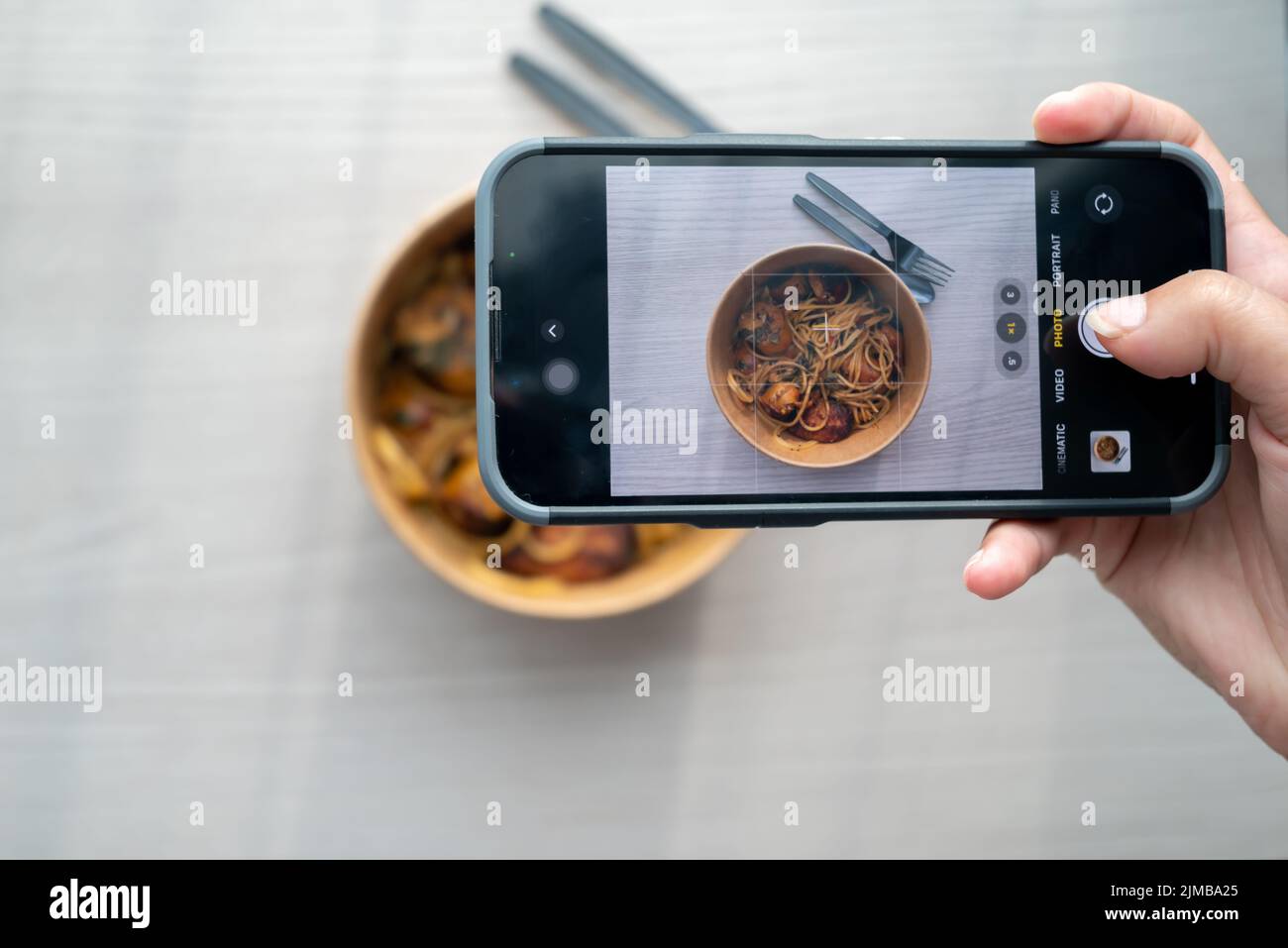 Shoot first eat later concept, shooting Thai spice herb pasta view ...
