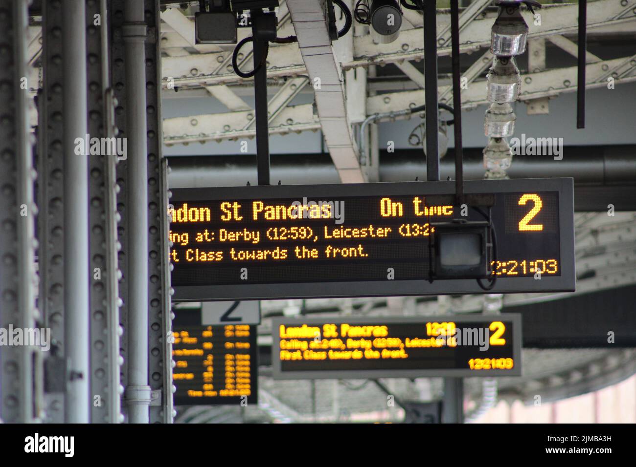 A shot of a train station departure screen on a platform at a railway ...
