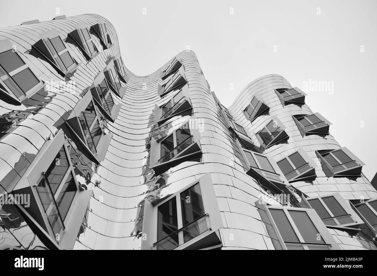 The mirrored metal facade of the Gehry buildings at the Media Harbour ...