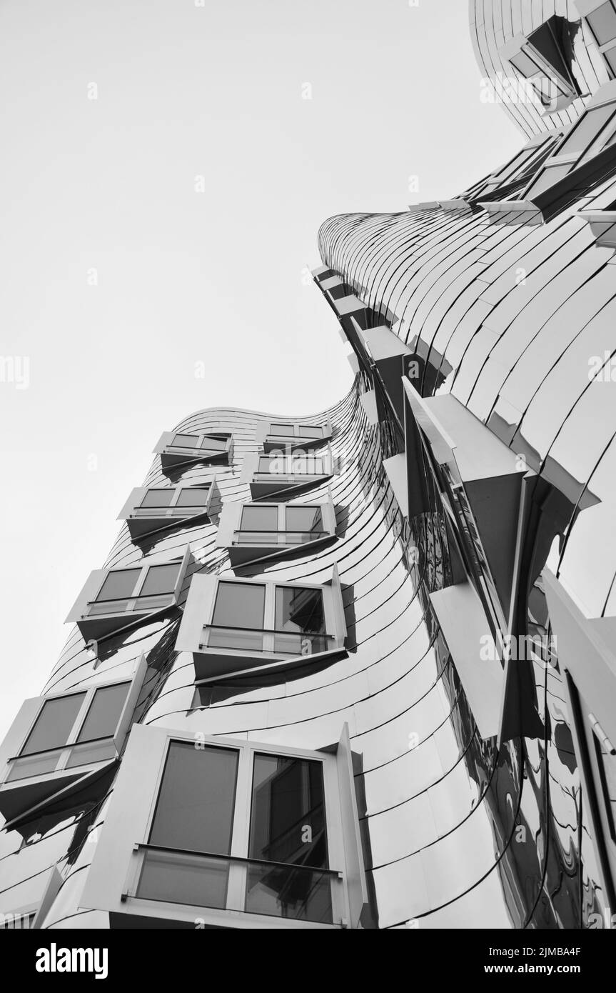 The mirrored metal facade of the Gehry buildings at the Media Harbour ...