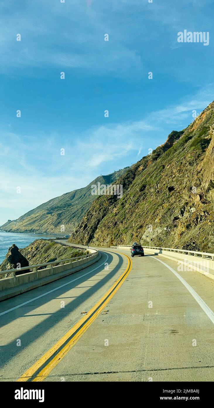 A beautiful view of the empty highway along with autumn trees under ...