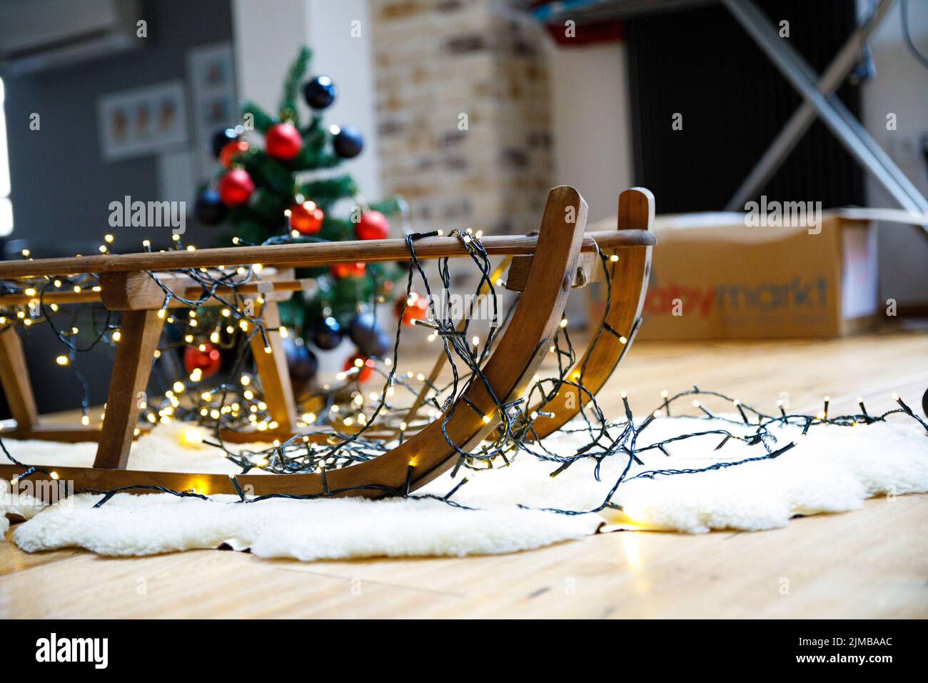 Christmas Sleigh with a christmas tree and lights Stock Photo - Alamy