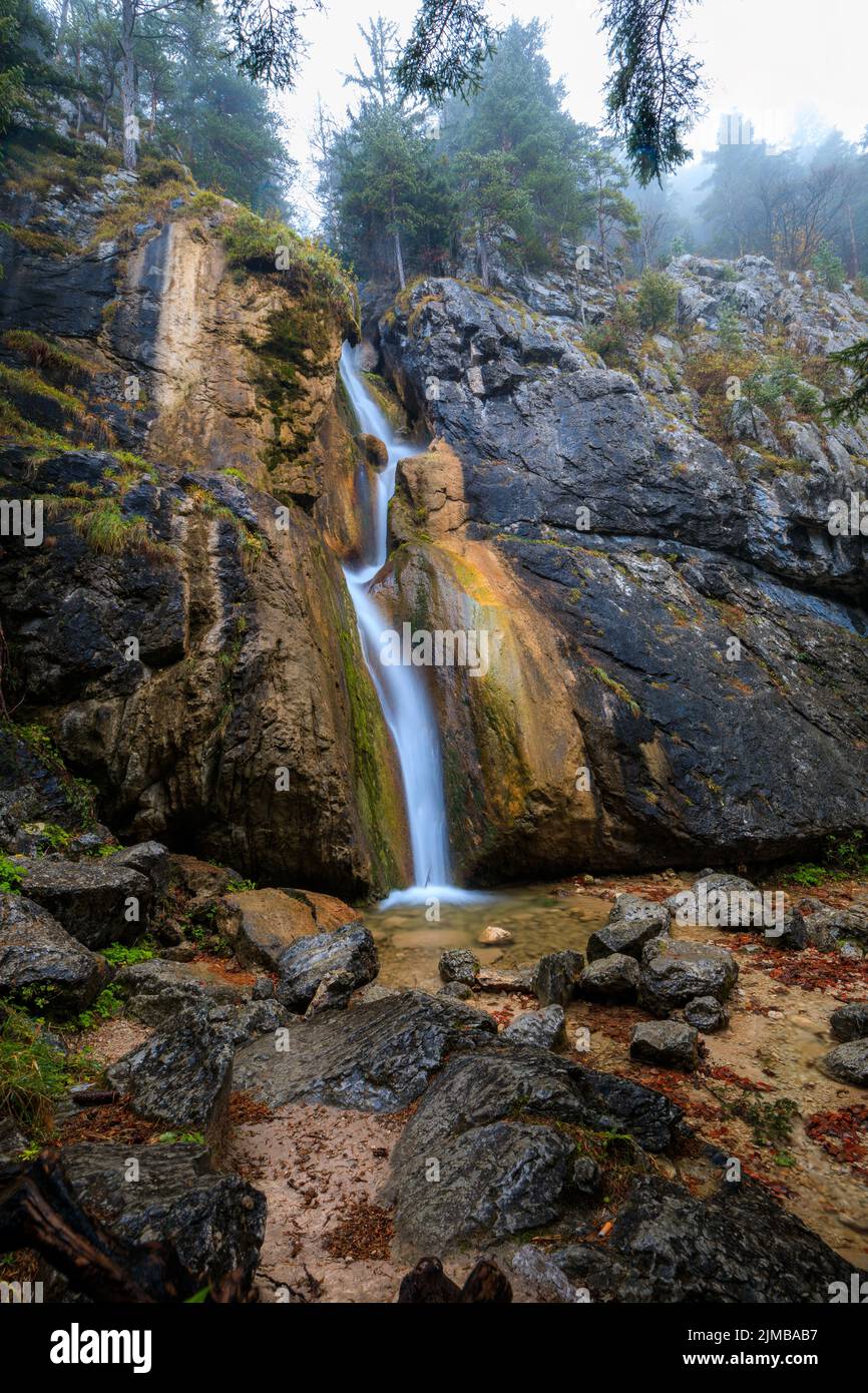 Waterfall in forest landscape long exposure flowing over rocks Stock ...