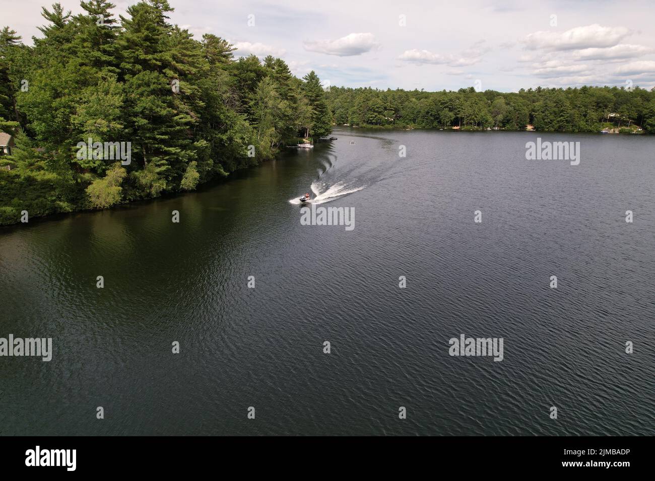A ship riding in the sea with green forest on the background Stock ...