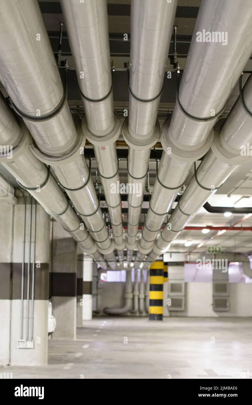 A vertical shot of the pipes in a parking lot Stock Photo - Alamy